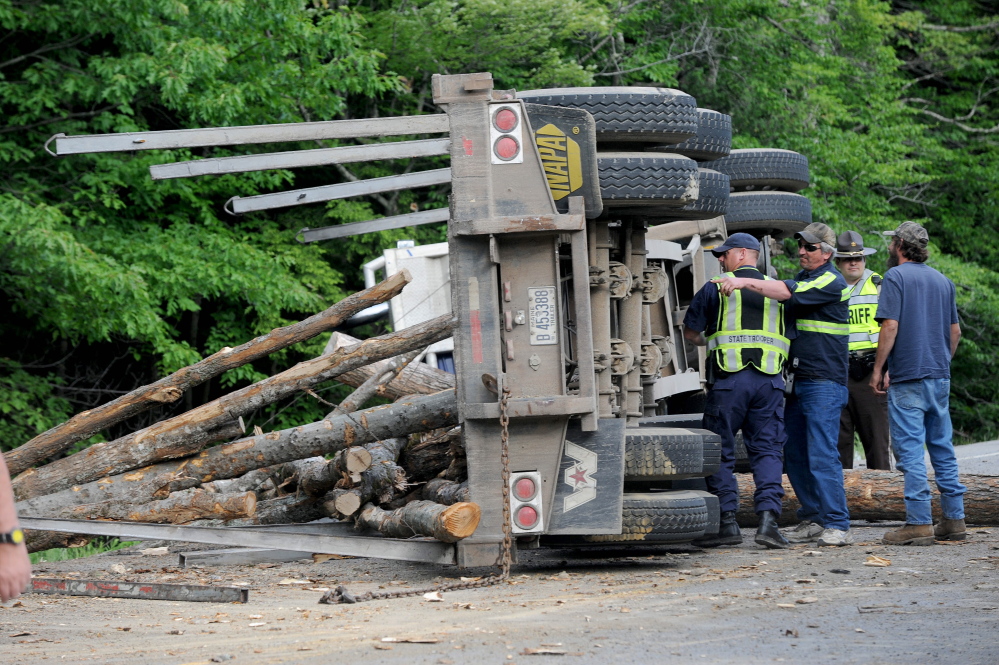 Five hurt when truck spills logs onto SUV
